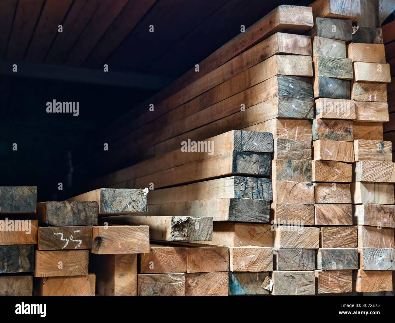 Stack of Raw Hardwood Timber Beams and blocks in lumber Storage Stock ...