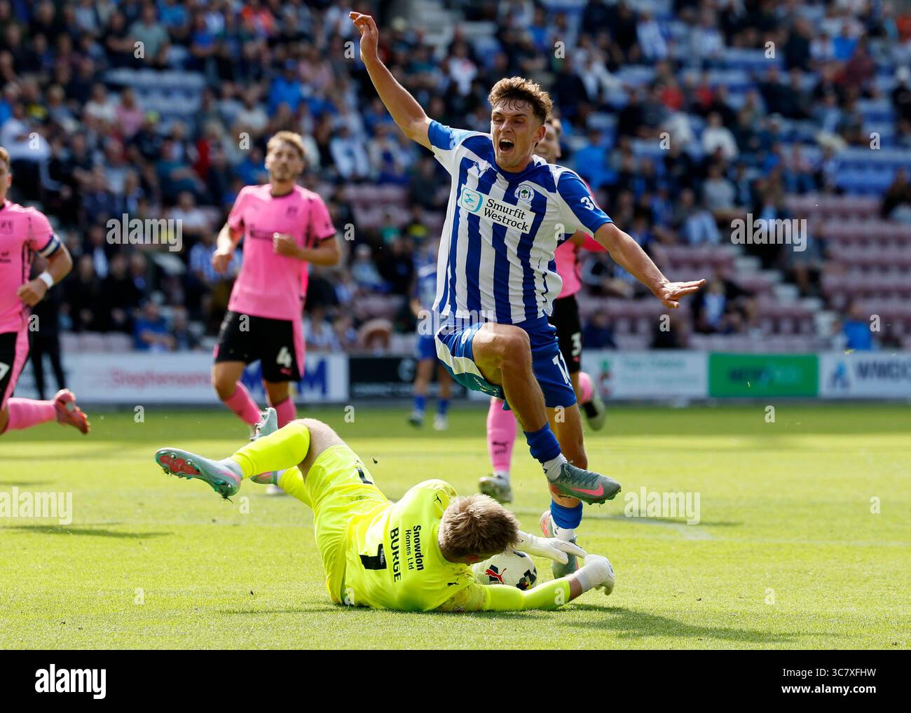 Northampton Town goalkeeper Lee Burge stops Wigan Athletic's Dara ...