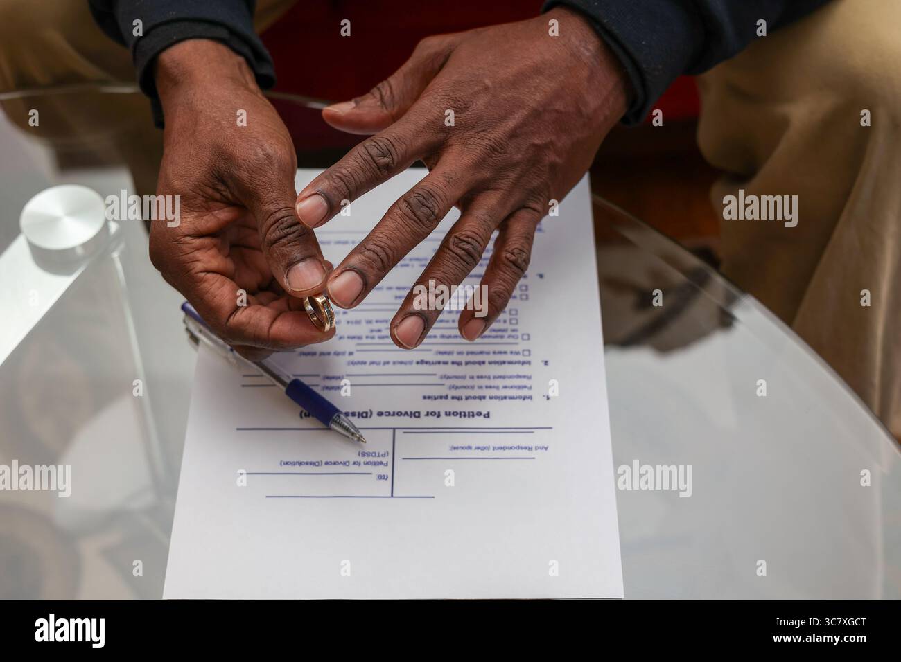 A black man signing divorce papers Stock Photo - Alamy