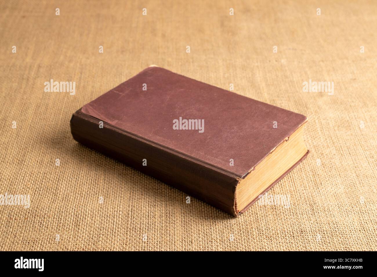 One old book on jute canvas, close-up Stock Photo - Alamy