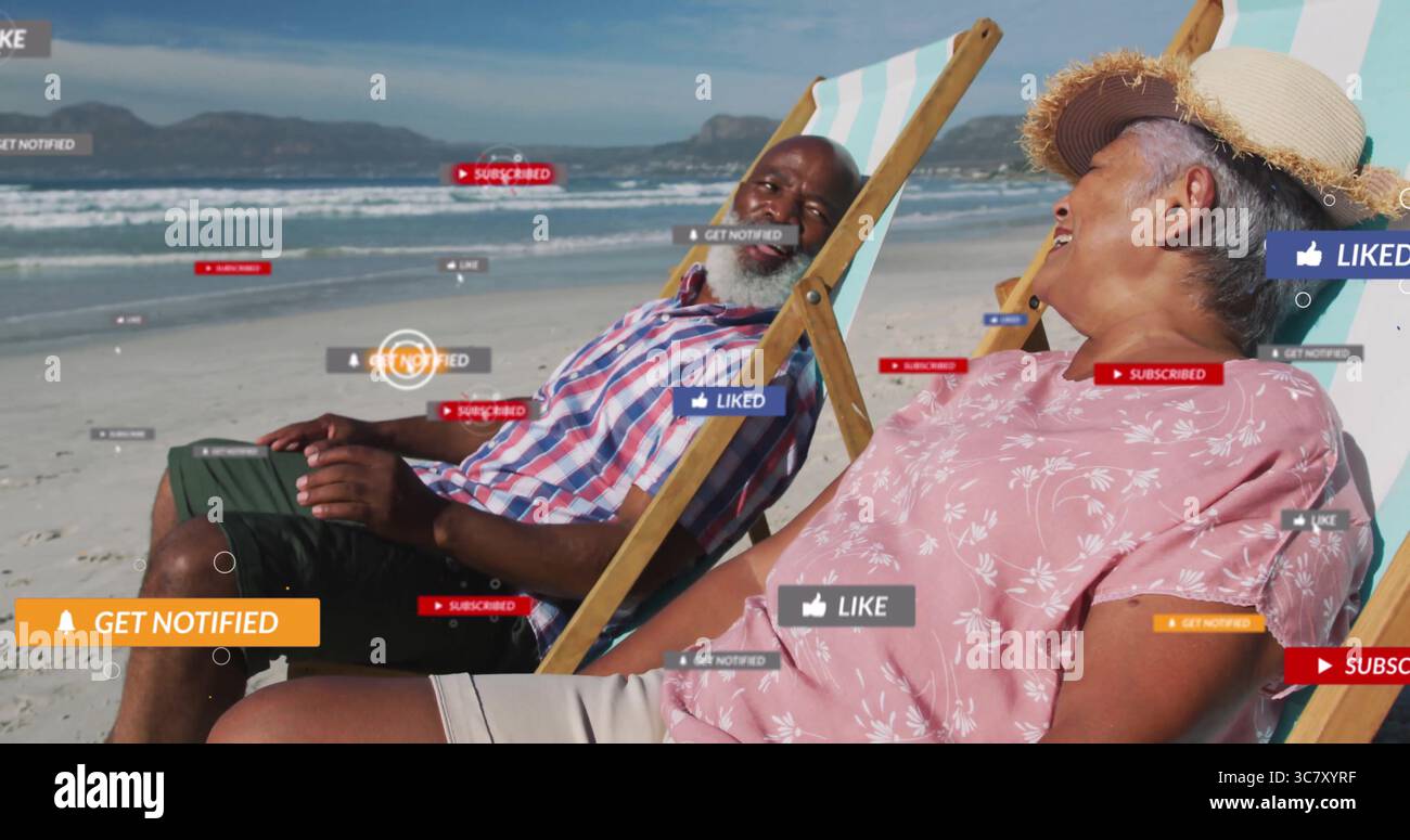 Reclining couple using smartphones on deck chairs at beach with ...