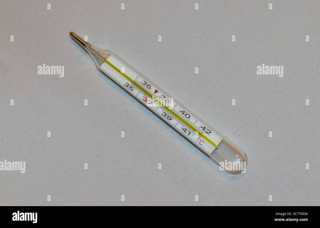 A clear thermometer shows scale with temperature marked in Celsius ...