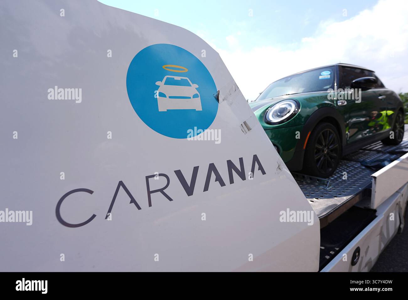 A 2020 Mini Cooper S hardtop sits on the back of a Carvana delivery ...
