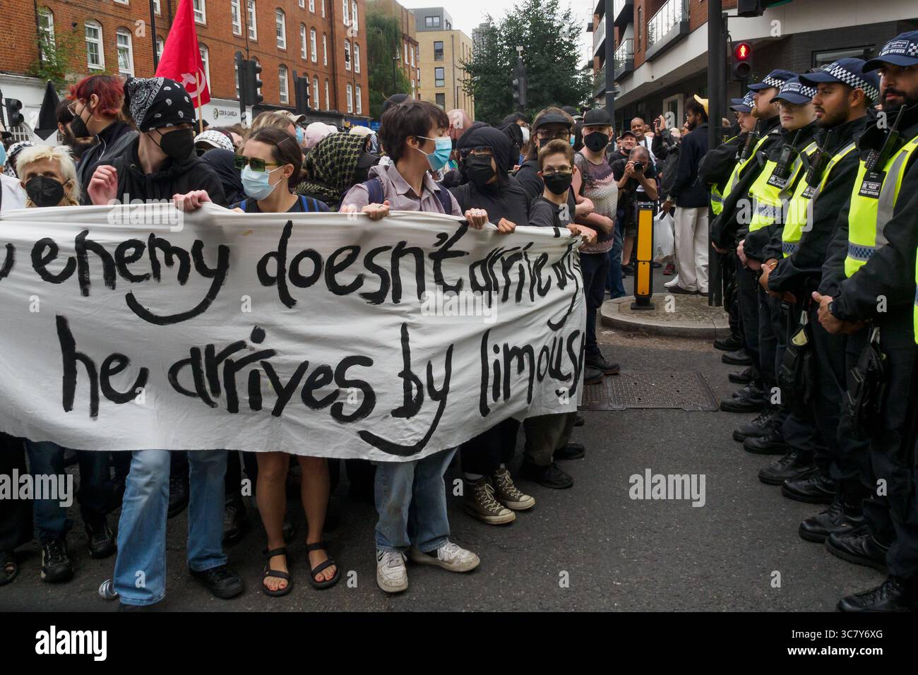 London, UK. 2 Aug 2025. A large block of anarchists ignore police ...