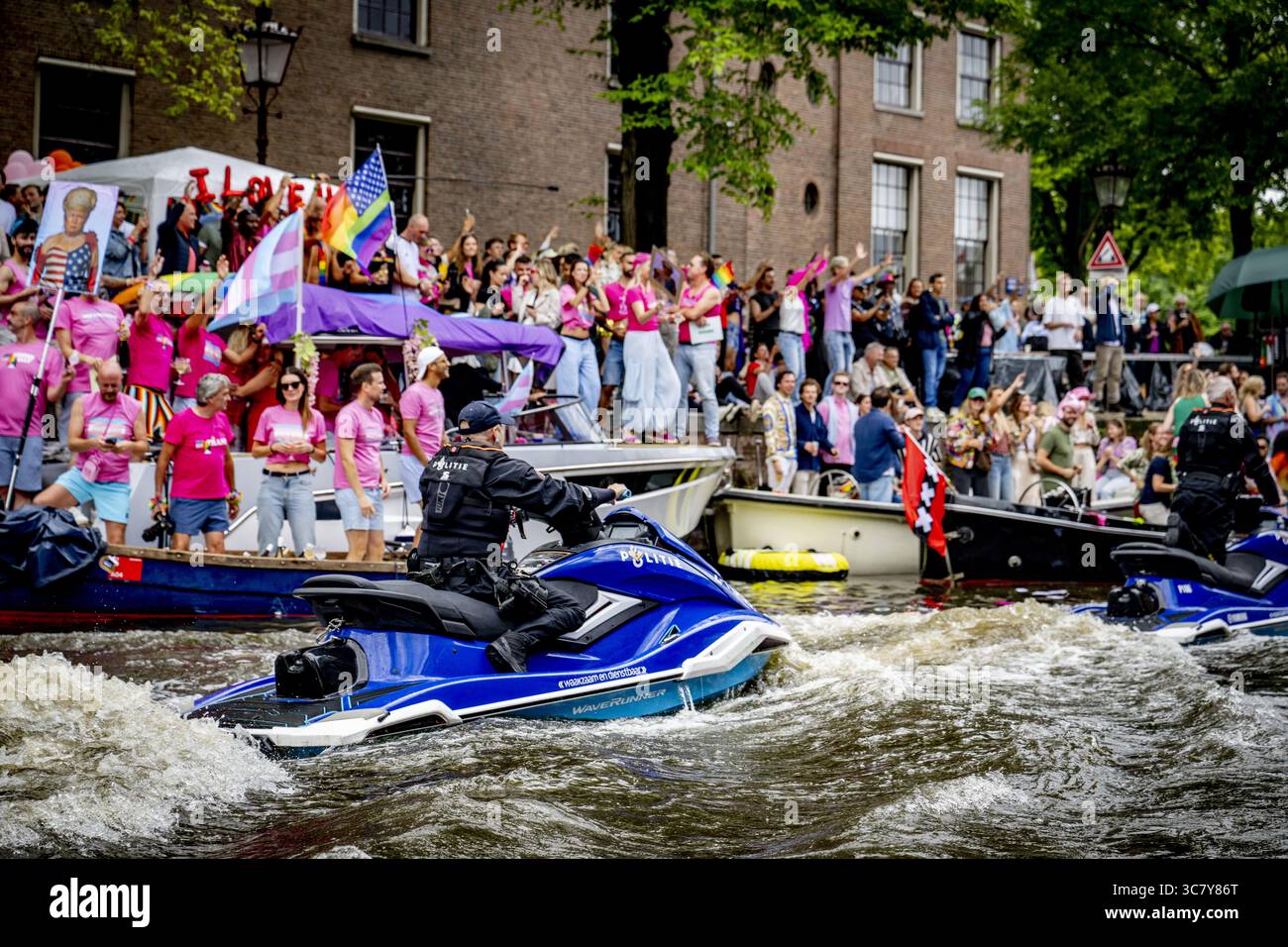 AMSTERDAM - Police surveillance on a jet ski during the canal parade ...