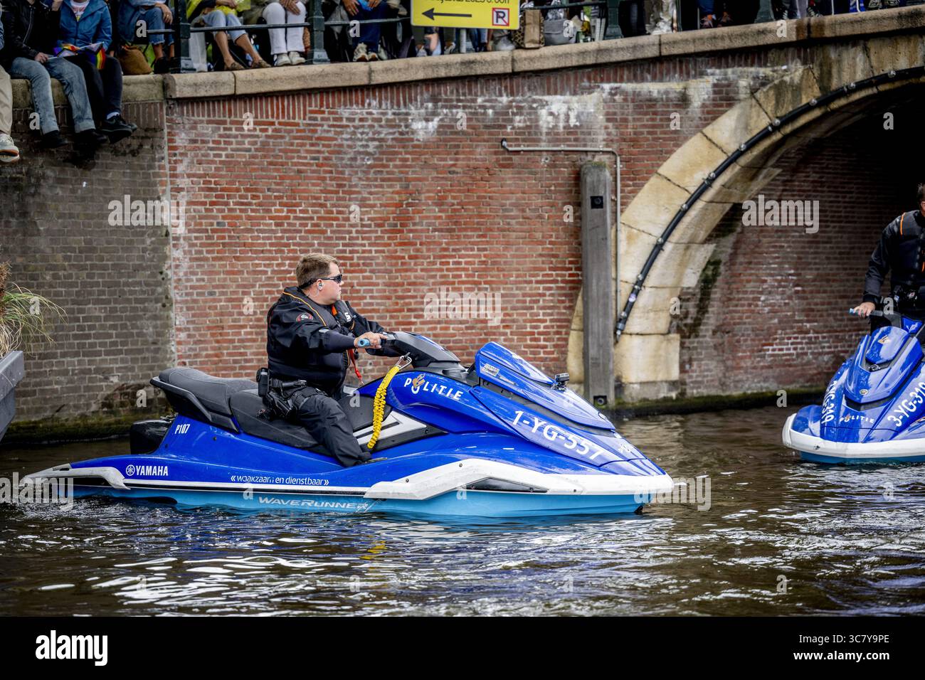 AMSTERDAM - Police surveillance on a jet ski during the canal parade ...