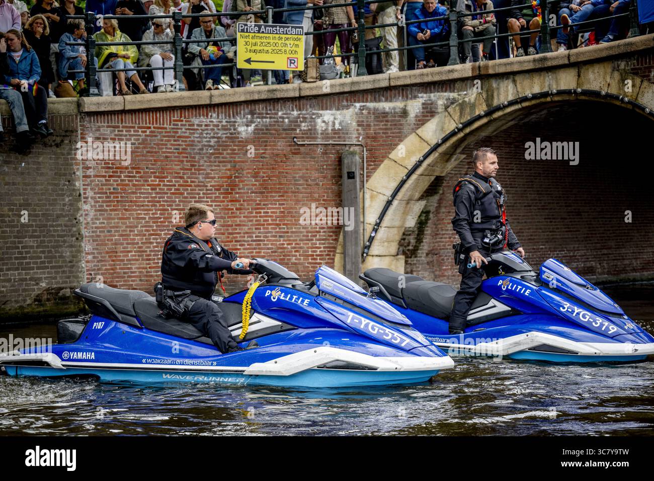 AMSTERDAM - Police surveillance on a jet ski during the canal parade ...