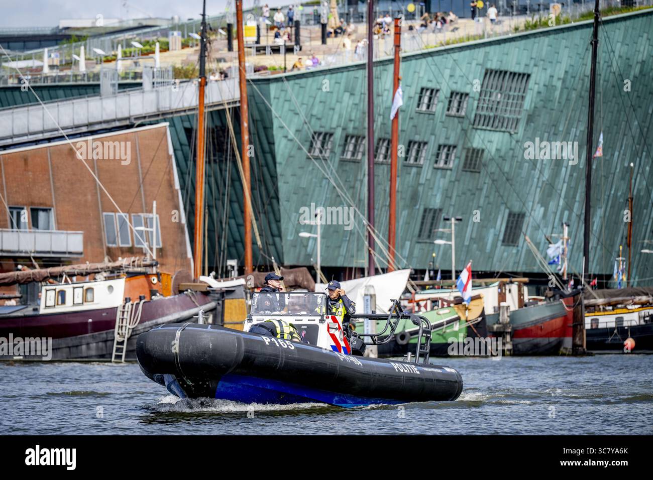 AMSTERDAM - POlitie guards with a police boat The Pride Amsterdam boat ...