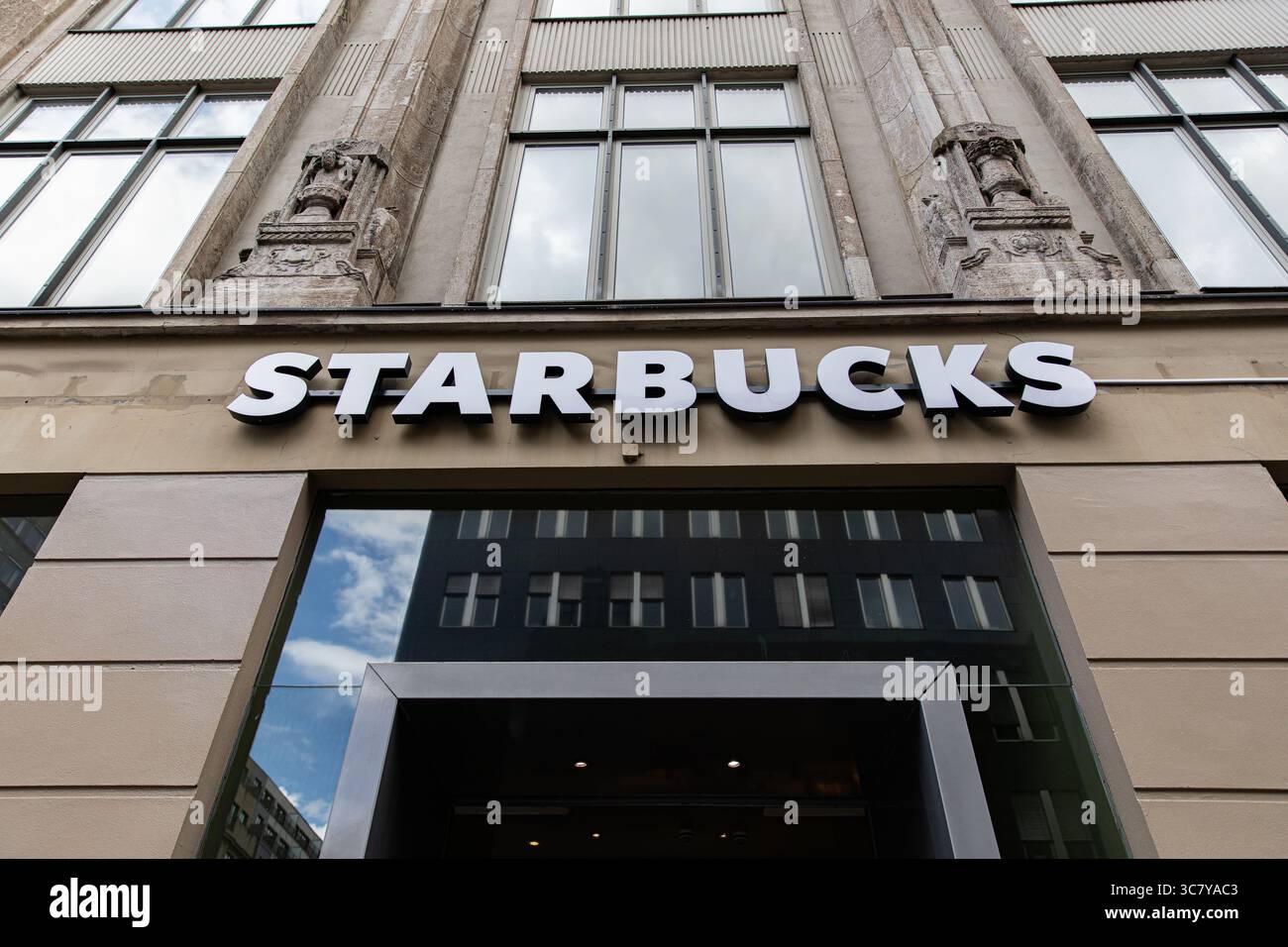 The Starbucks logo is pictured on the exterior of a historic building ...