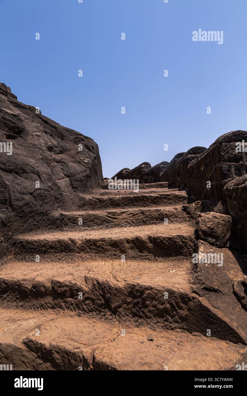 Ancient Stone Steps Carved into Rocky Terrain Under Clear Sky at ...