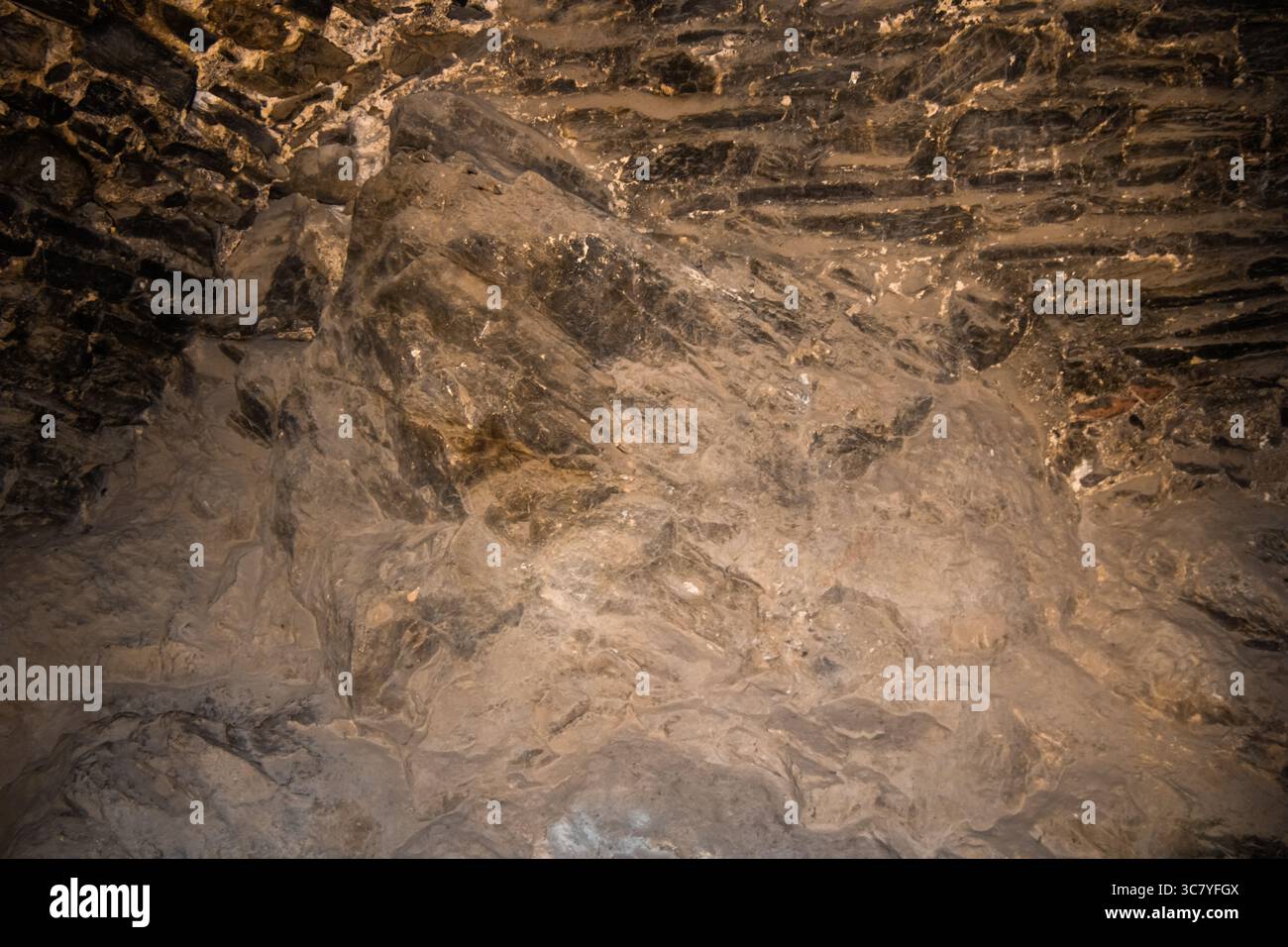 An illuminated section of underground rock displays rich textures and ...
