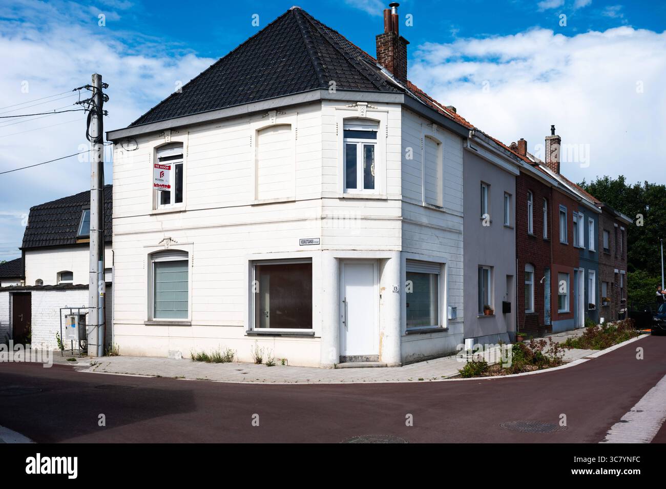 White residential corner house in a row in Harelbeke, West Flanders ...
