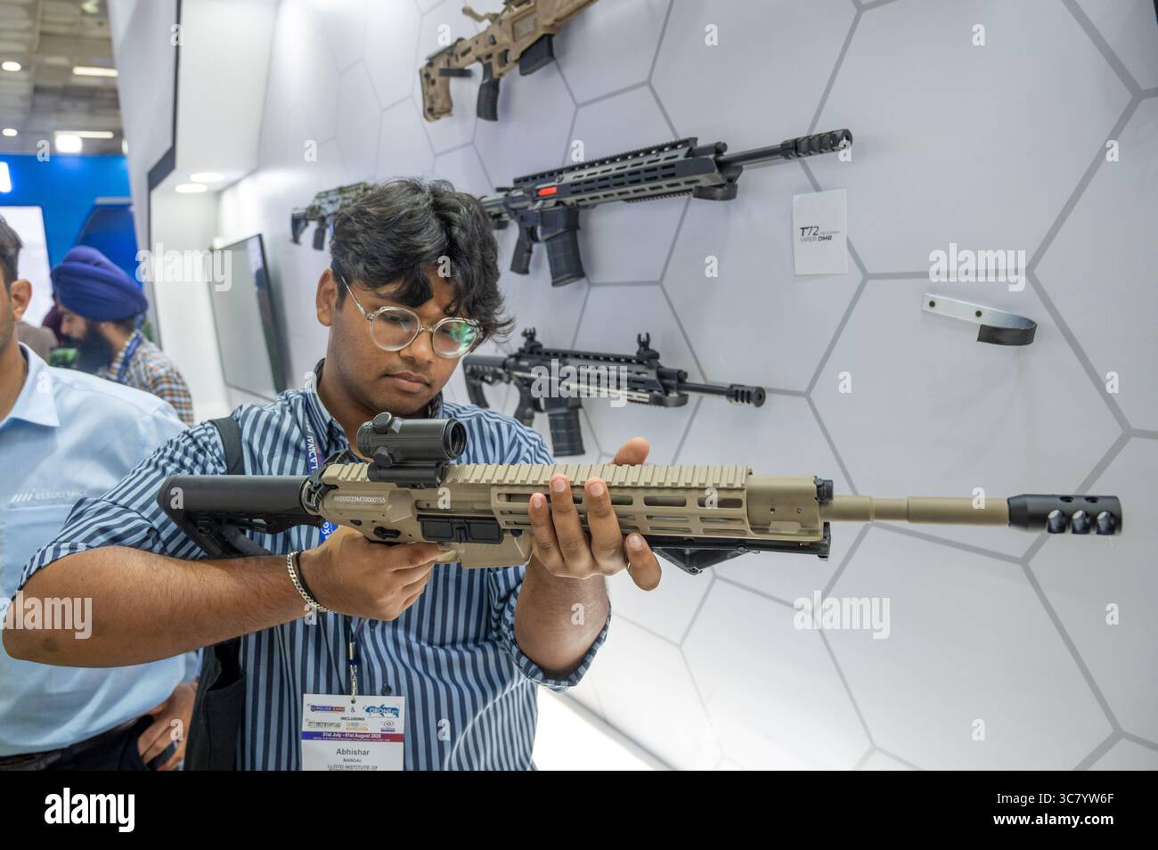A boy aims an M72 assault rifle manufactured by SSS Defence during the ...