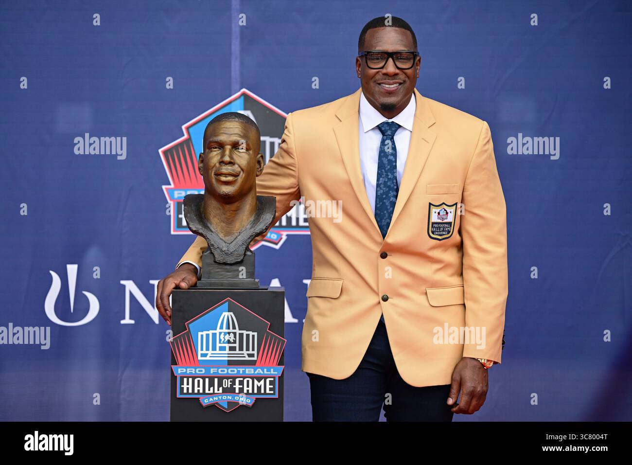 Former NFL player Antonio Gates poses with his bust during an induction ...