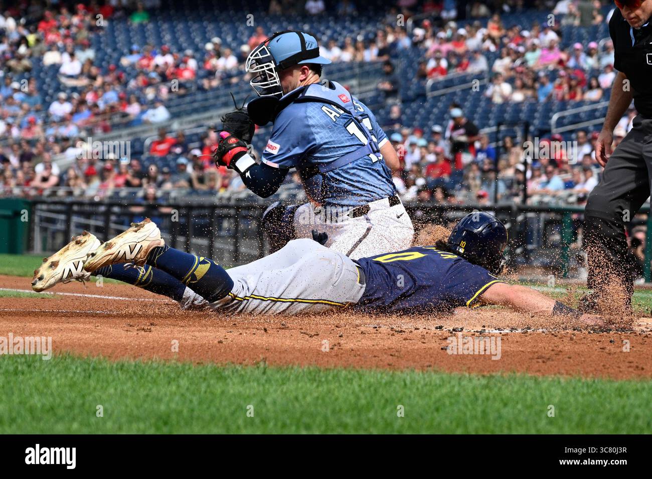 Milwaukee Brewers' Sal Frelick, front, scores on a single by Christian ...