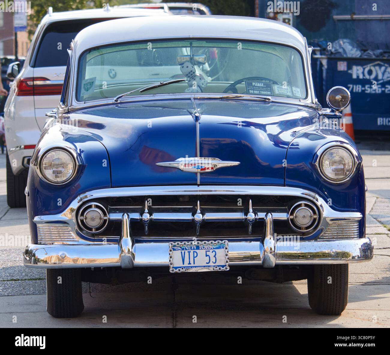 a blue and white chevrolet belair four door sedan, parked on a city ...