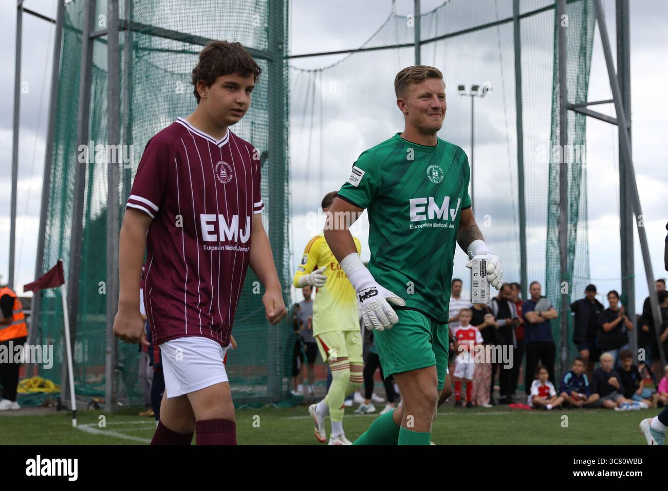Chris Haigh, of Chelmsford City walks into the pitch with his mascot ...
