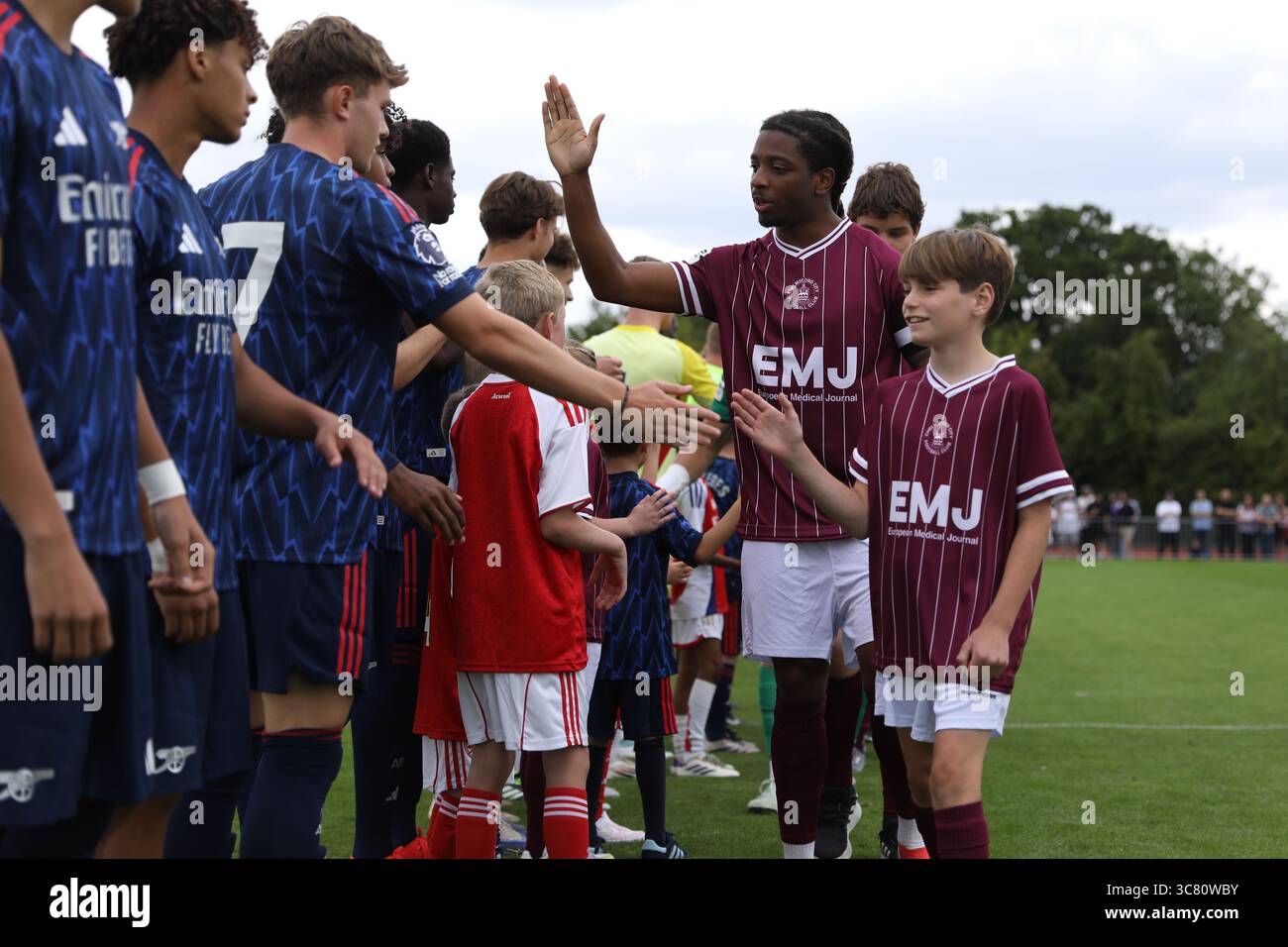 Dom Odusanya, of Chelmsford City shakes hands with Arsenal Academy ...