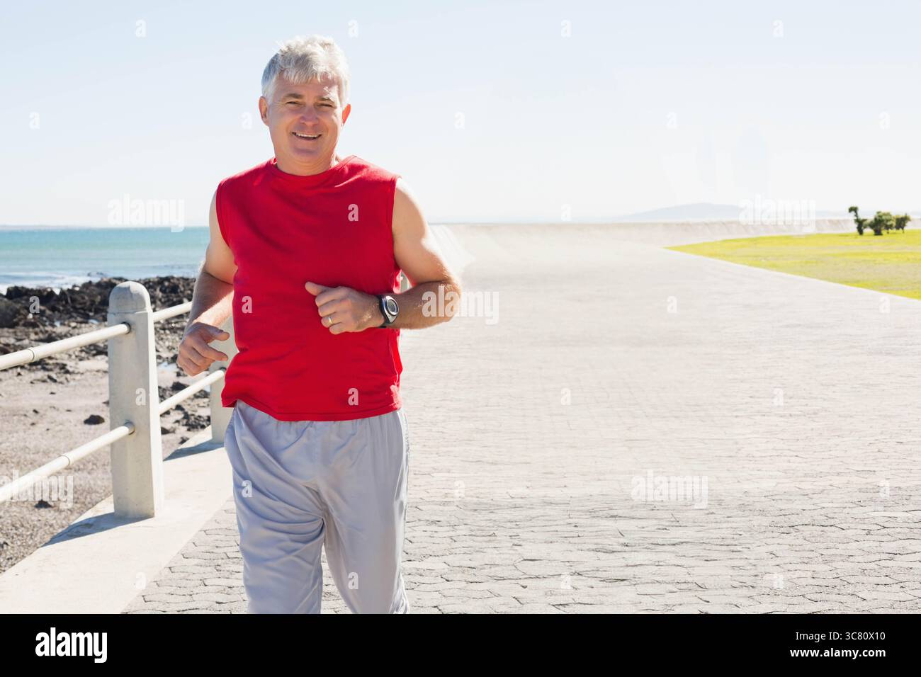 Senior man jogging seaside promenade hi-res stock photography and ...