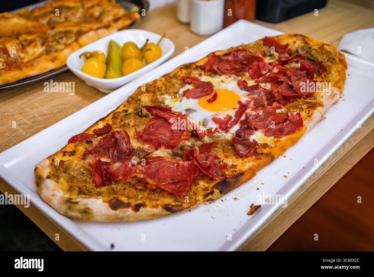 A hot Turkish pide with pastirma cured beef and an egg, fresh out of ...