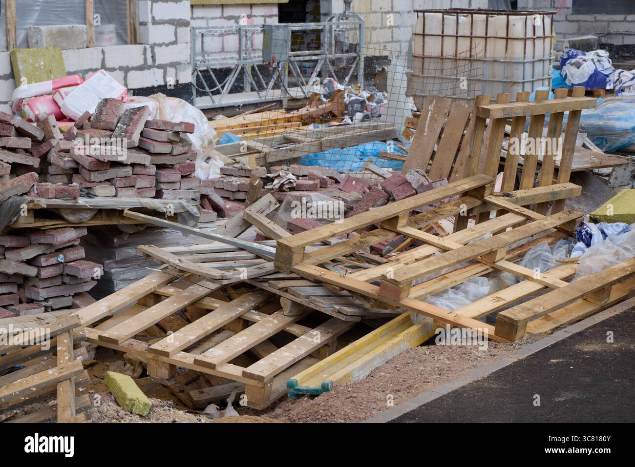 The construction site features various wood and brick materials ...