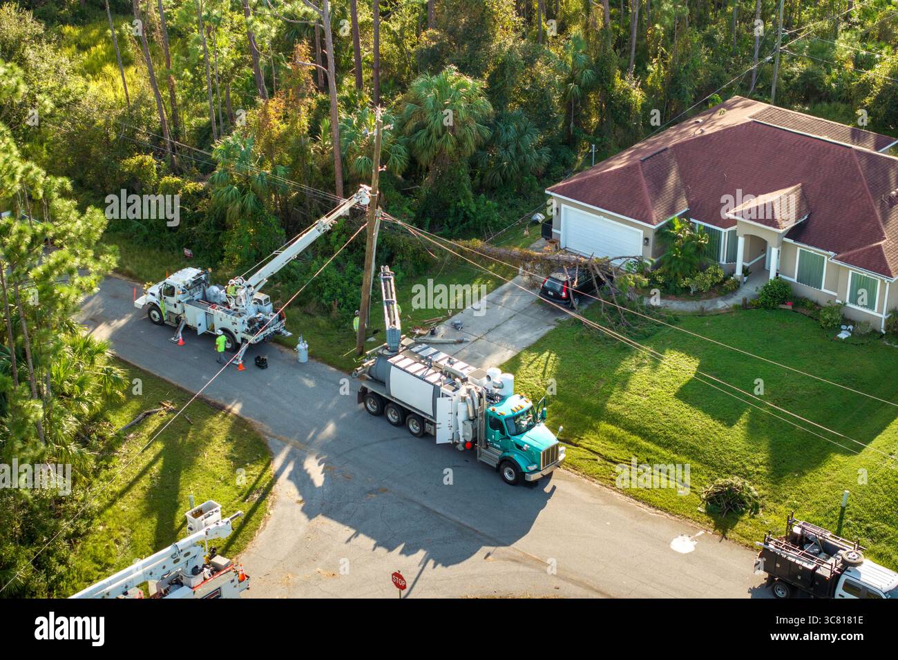 Electrician workers fixing power lines after outage. Repair of damaged ...