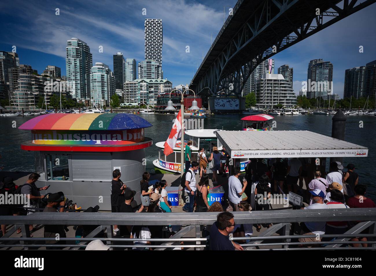 Tourists line up to take an Aquabus water taxi tour of False Creek ...