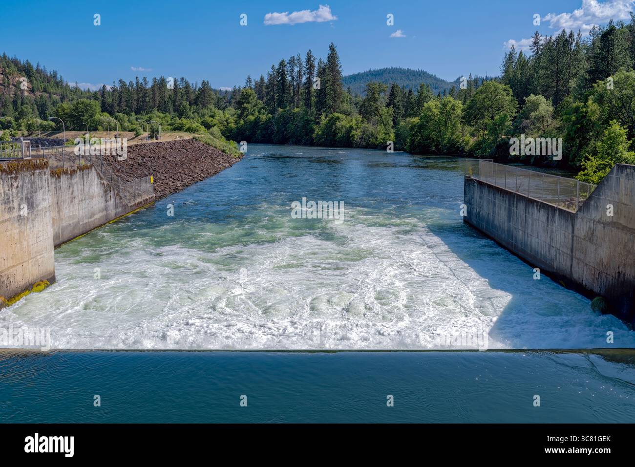 The Rogue River waters rushing over the man-made waterfall at the Cole ...