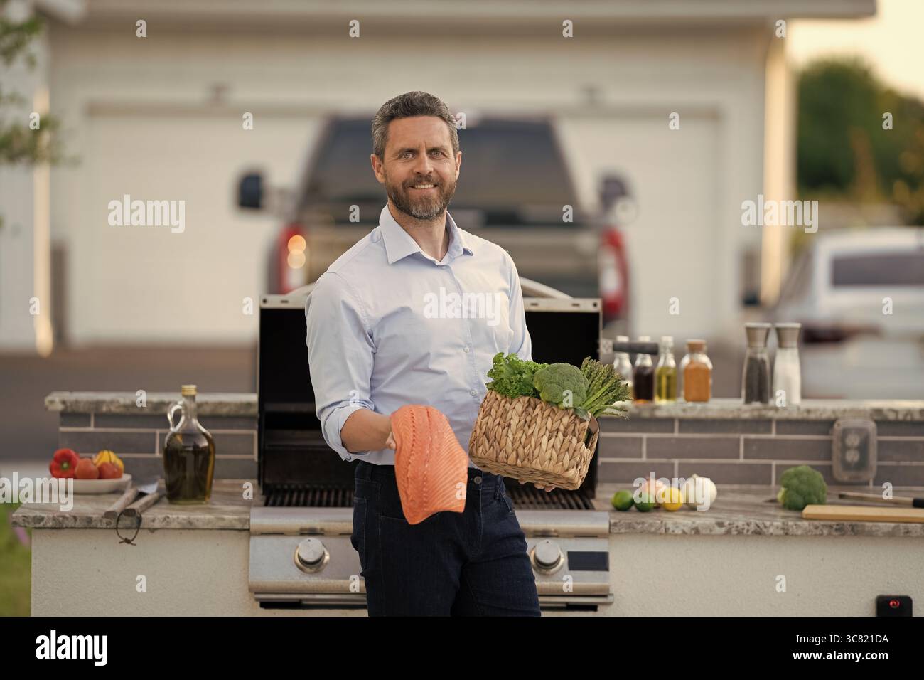 Salmon fillet. Man roast fish fillet in barbecue at backyard. Grilling and BBQ. Roasted salmon ...