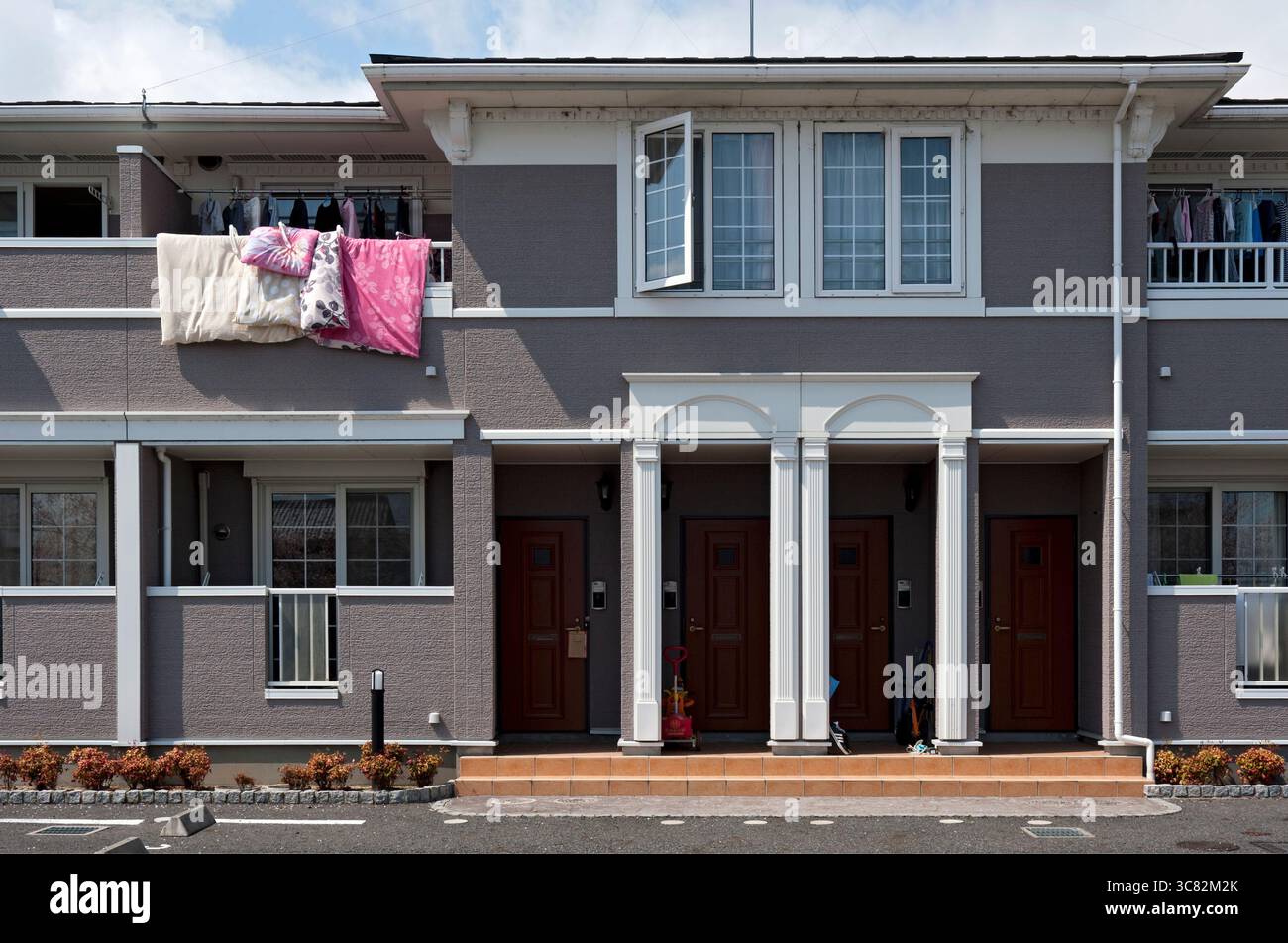 Japanese futon bedding hanging over a residential balcony railing ...