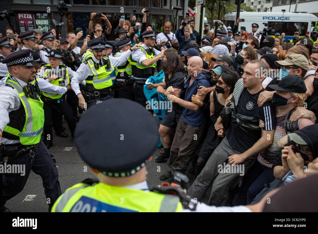 Metropolitan Police officers face members of ANTIFA during the ...