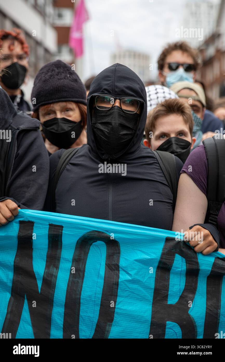 A female member of ANTIFA wears a mask during the demonstration ...