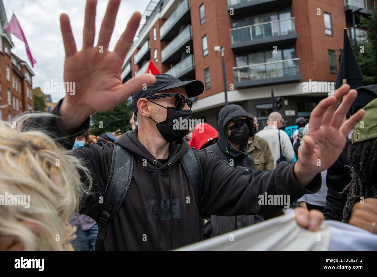 A member of ANTIFA pushes back demonstrators during the demonstration ...