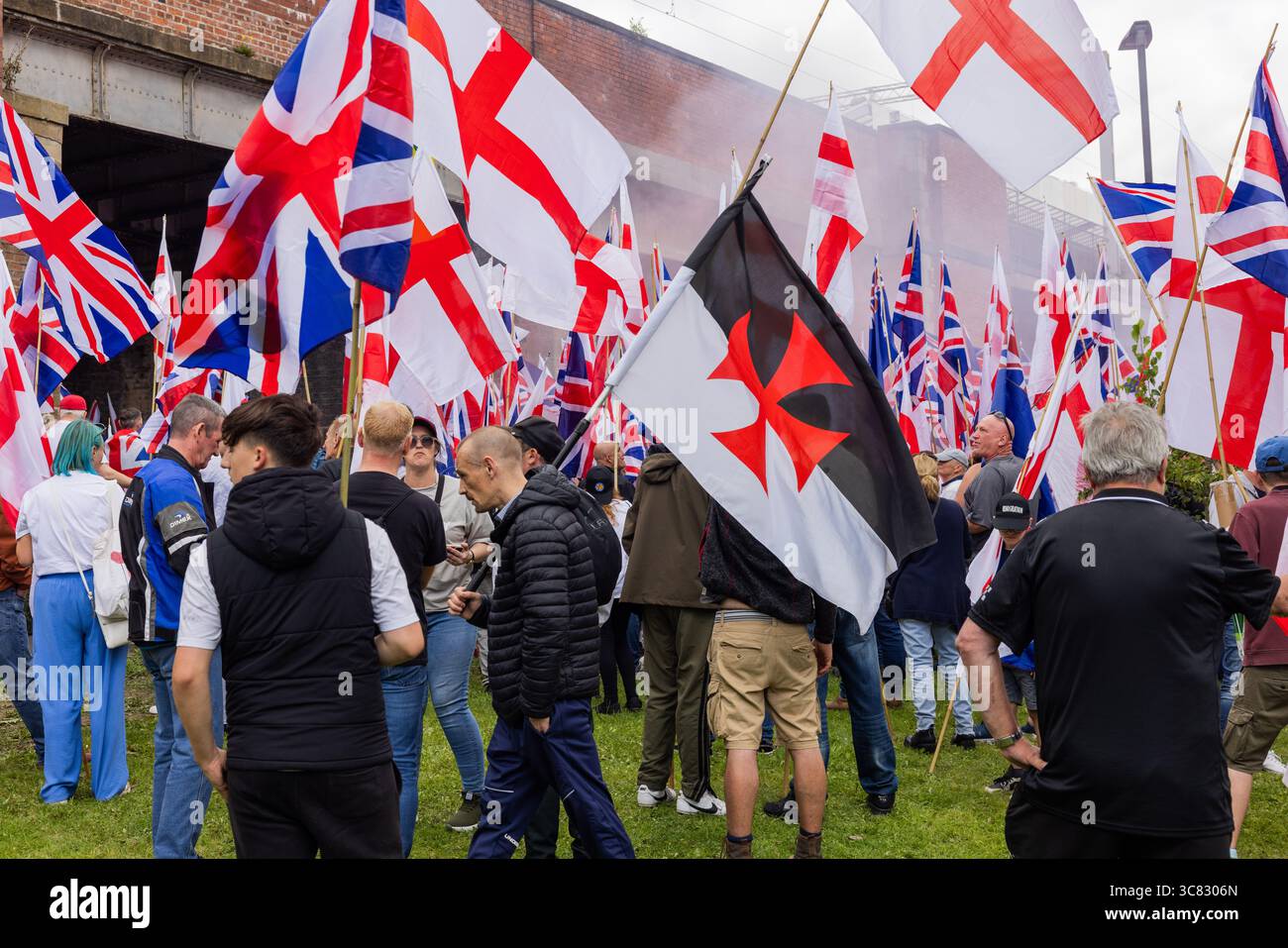 Manchester, UK. 02 AUG, 2025. Man carries Knights Templar flag as ...