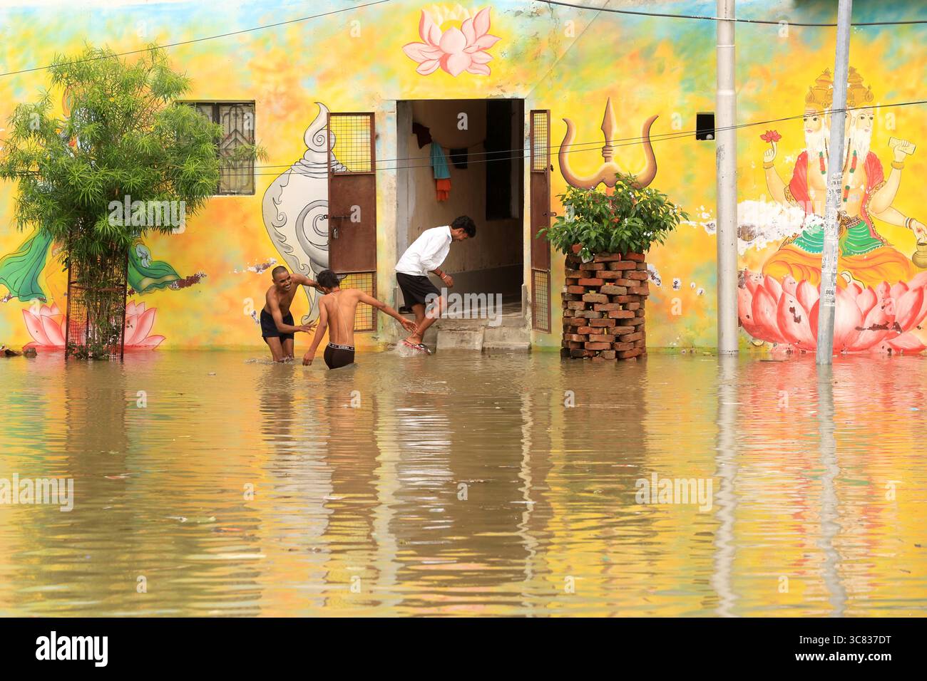Indian people from a flooded area amid a rise in the water level of the ...