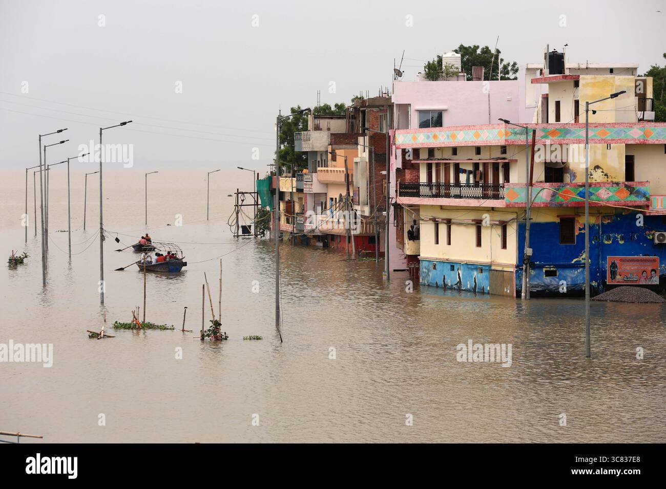 Indian people from a flooded area amid a rise in the water level of the ...