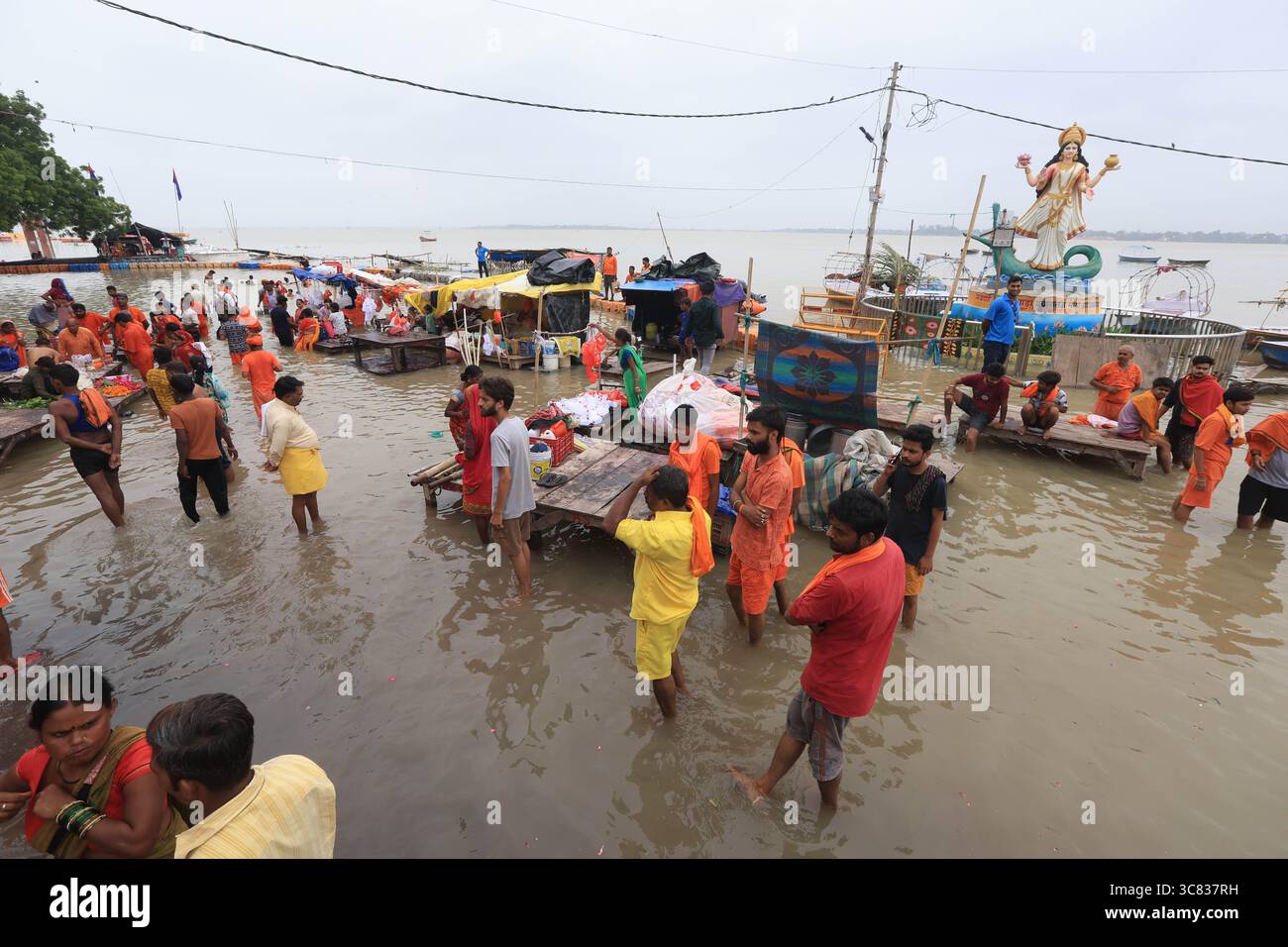 Indian people from a flooded area amid a rise in the water level of the ...