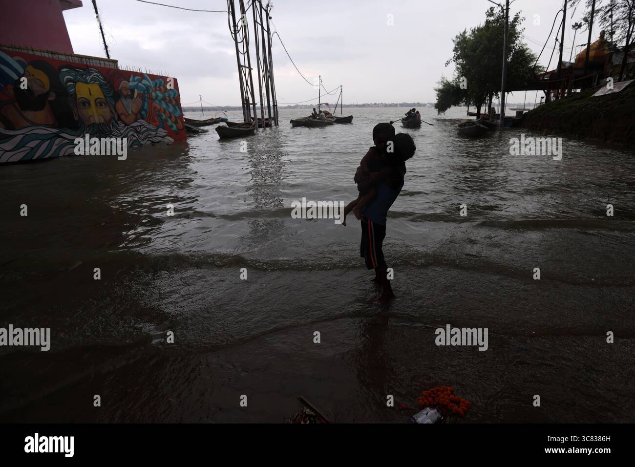 Indian people from a flooded area amid a rise in the water level of the ...