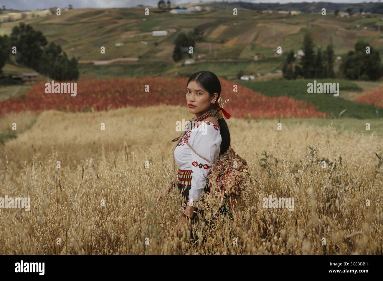 Indigenous farmer woman, wearing traditional clothing, stands proudly ...