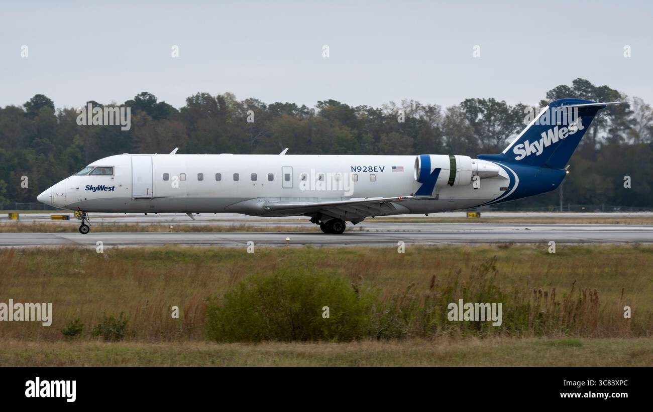A SkyWest Airlines regional jet on a runway, ready for takeoff. The ...