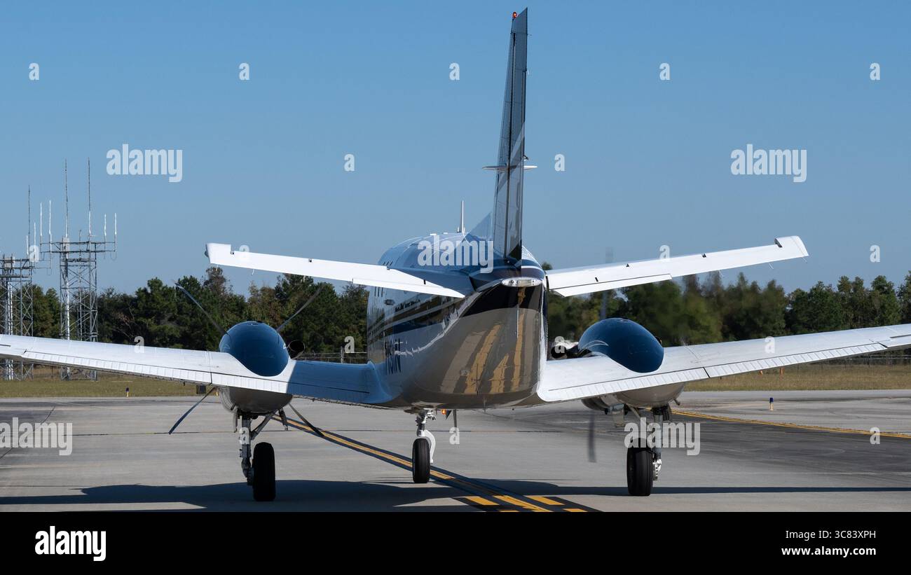 Rear view of a twin-engine propeller airplane on a runway Stock Photo ...