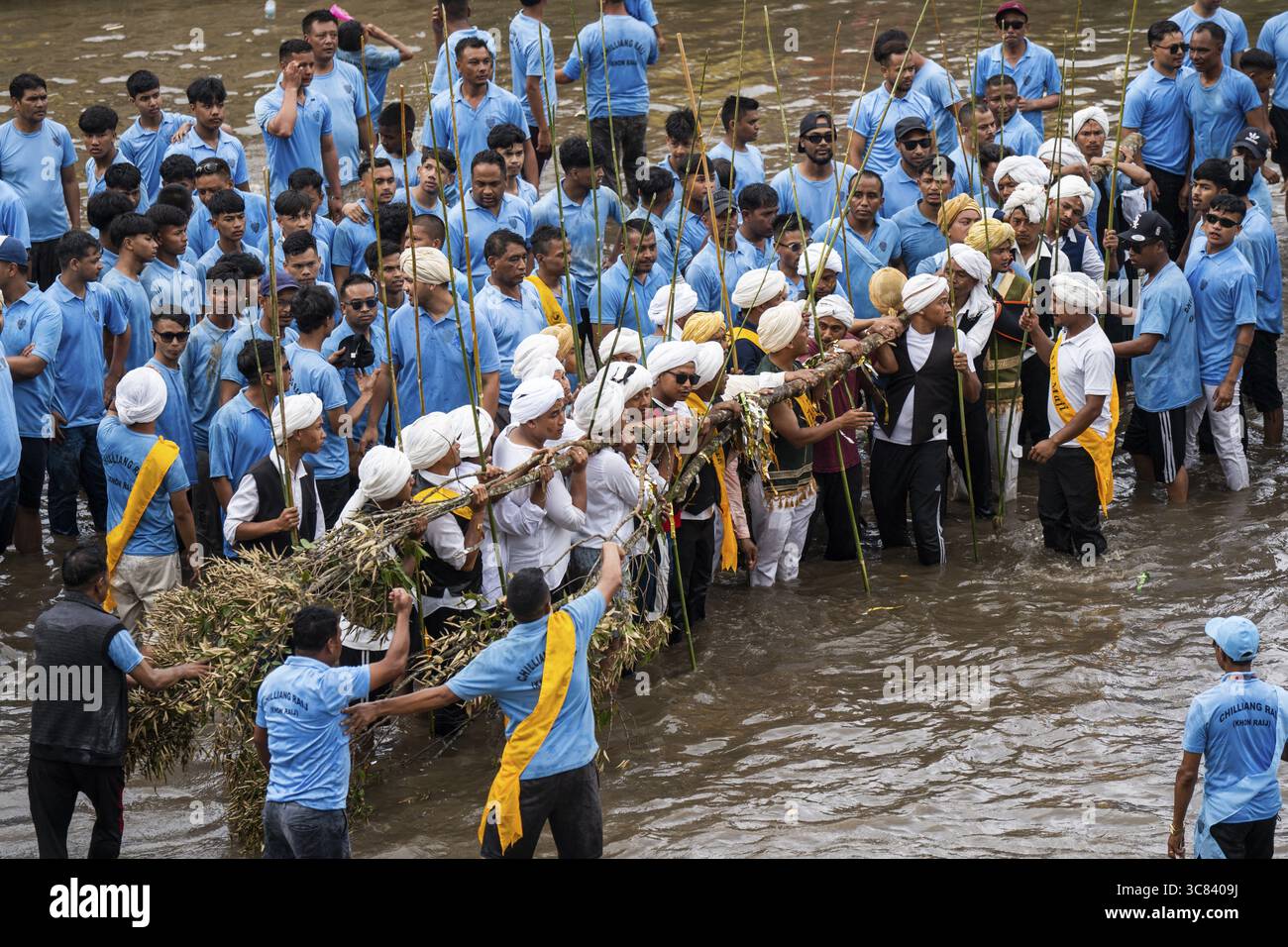People from the Pnar community perform rituals as they using a tree to ...