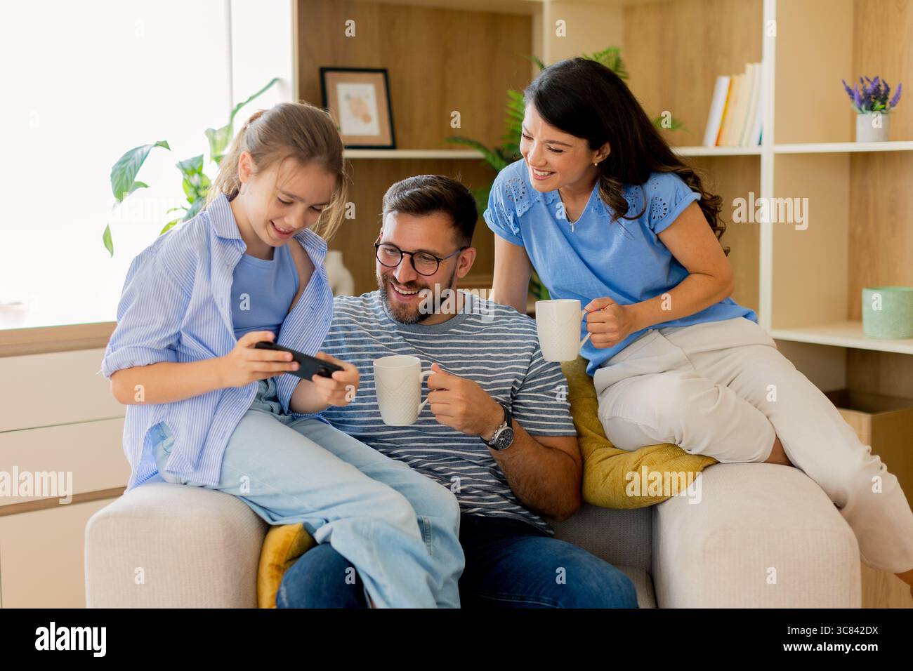 Joyful family interaction unfolds hi-res stock photography and images ...