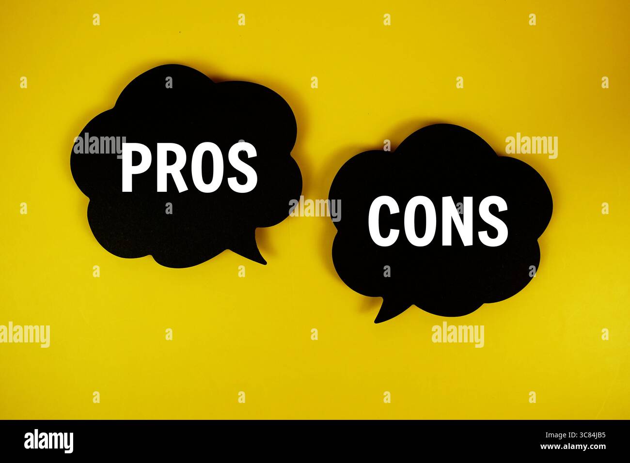 Pros And Cons text on speech bubble top view on yellow background Stock ...