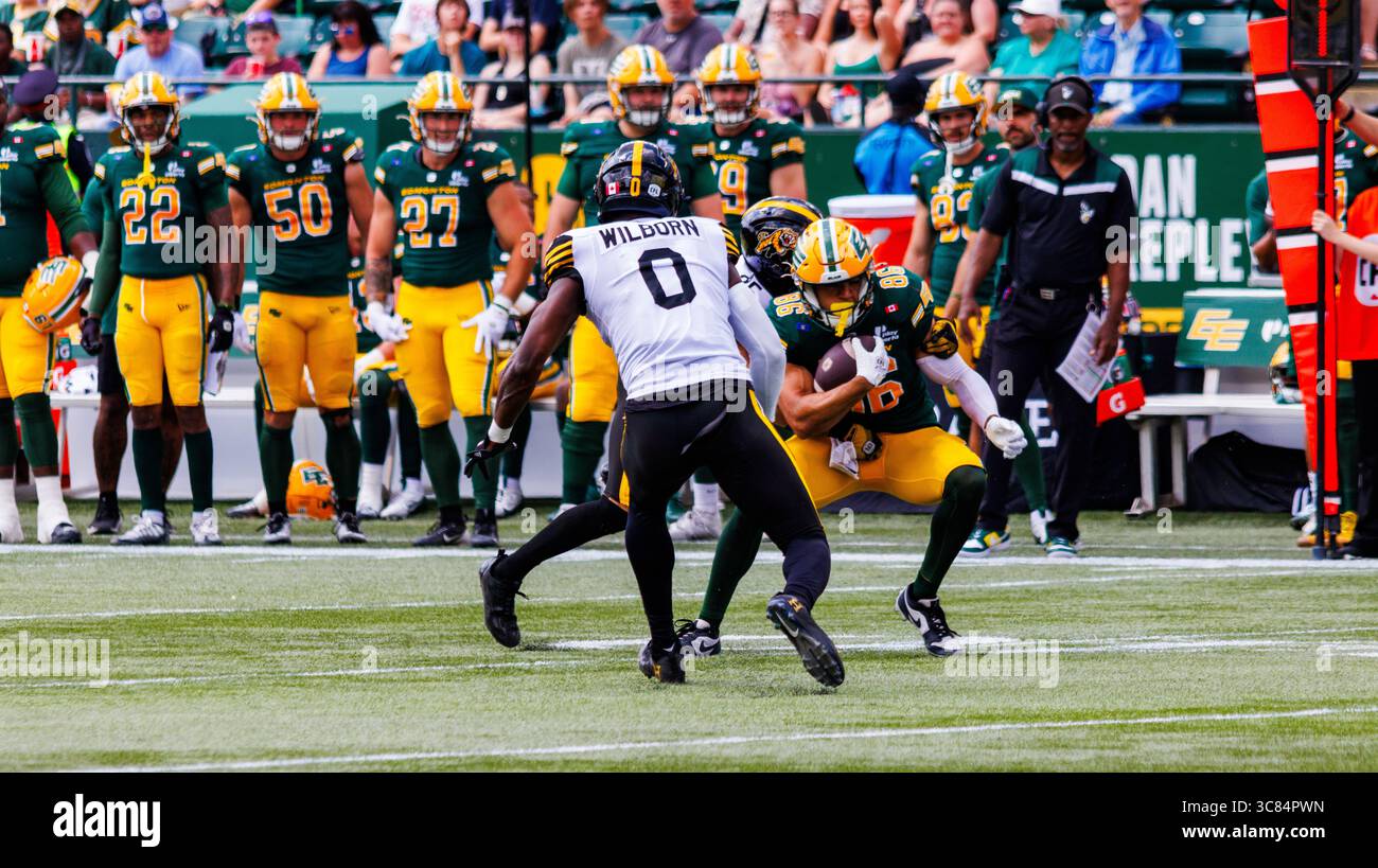 (86) Arkell Smith of the Edmonton Elks gets hit by Hamilton Tiger Cat ...
