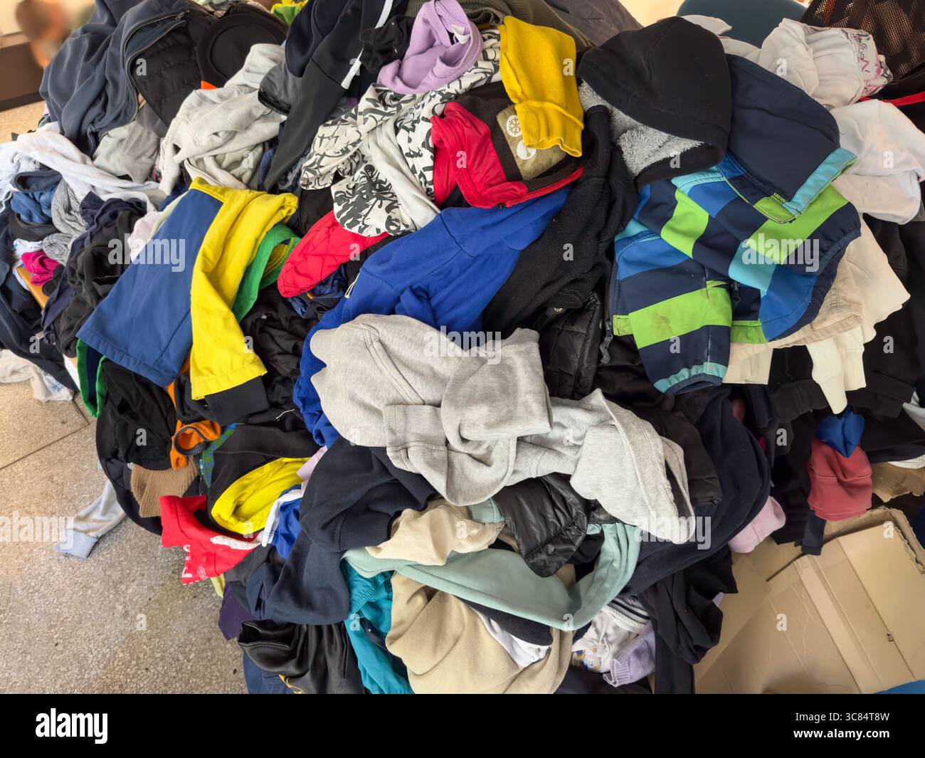 Pile of Unsorted Clothes on Cardboard Box – Lost and Found, Donation, or Recycling Concept. fast ...
