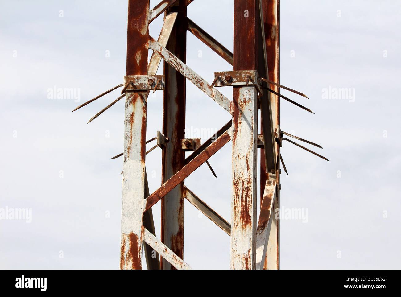 The base of a steel electricity transmission tower shows significant ...