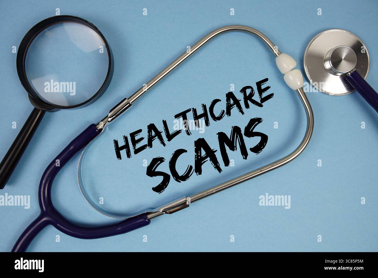 Healthcare Scams text with Stethoscope and magnifying glass on blue ...
