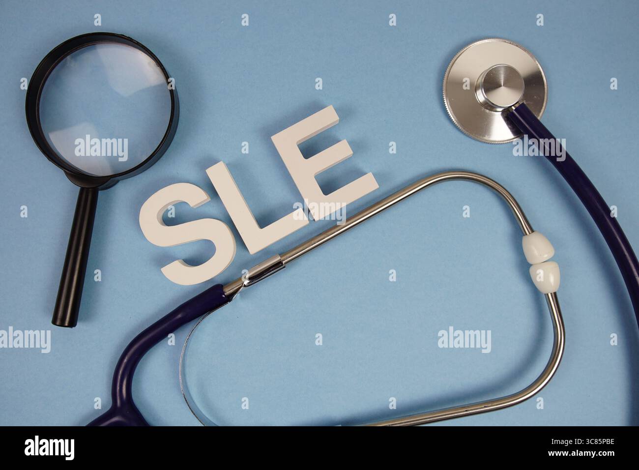 SLE Systemic Lupus Erythematosus text with stethoscope on blue ...