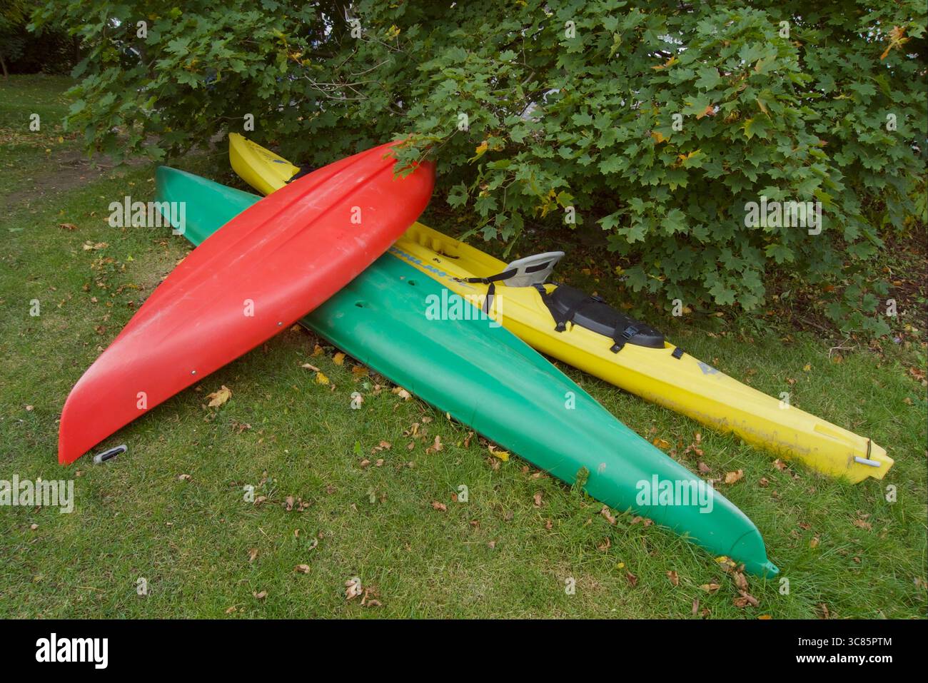 Three colourful canoes Stock Photo - Alamy